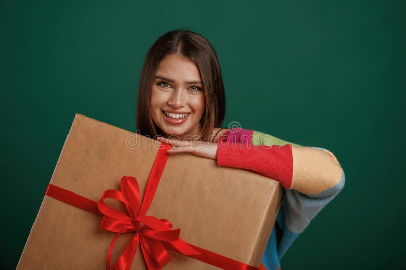 Large Gift Box in Hands. Young Woman is Standing Against Green ...