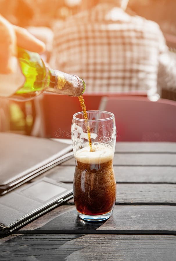 A Large Glass of Dark Beer on a Pub Background on a Wooden Table ...