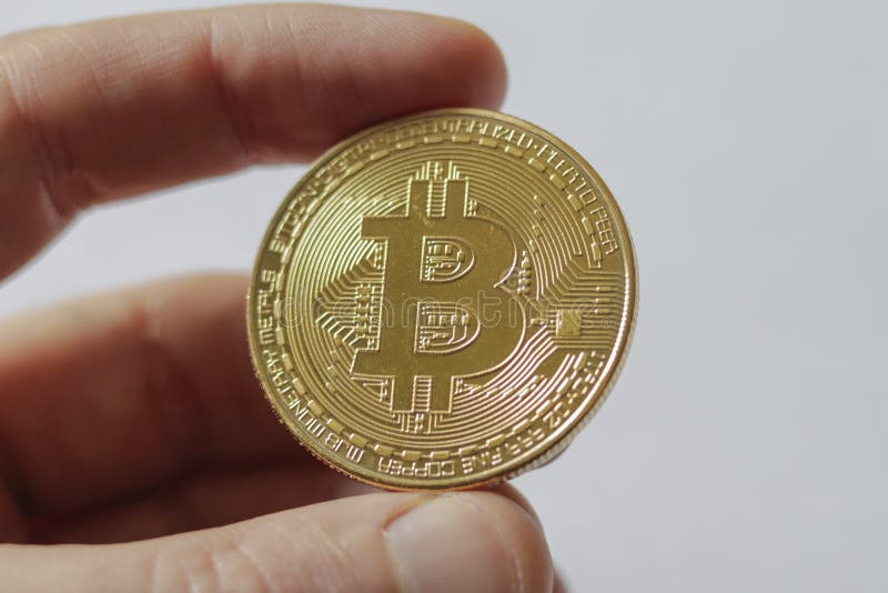 A Large Gold Bitcoin Token in Hand Stock Image - Image of currency ...