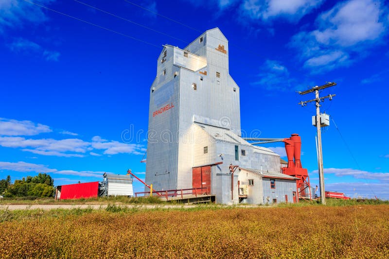 A Large Grain Silo with a Red Roof Stock Photo - Image of prairie ...