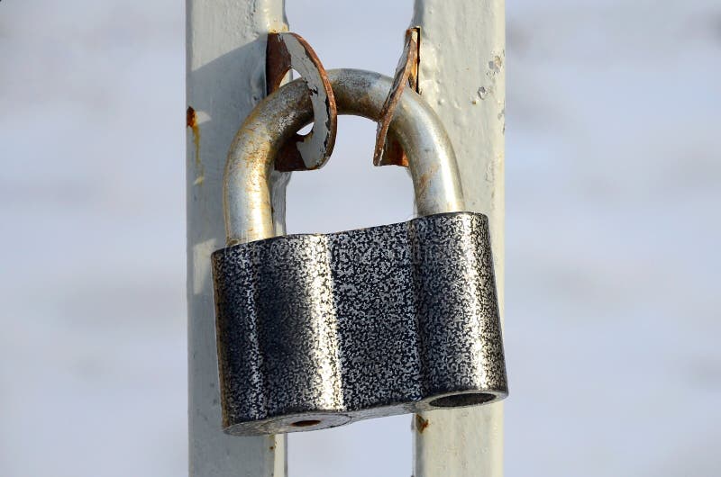 A Large Gray Padlock Hangs on a Metal Gate Stock Image - Image of ...