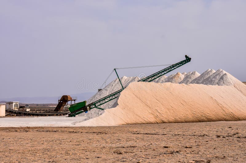 A Large Green Machine is Moving Sand from a Pile Stock Photo - Image of ...