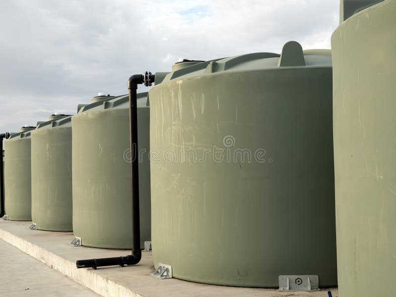 Large Green Water Storage Tanks and Overflow Piping Stock Photo - Image ...