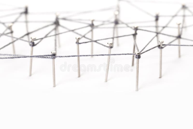 A Large Grid of Pins Connected with String. Communication, NetwA Large ...
