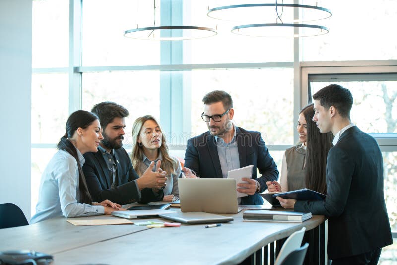 Large Group of Businesspeople Looking at the Laptop at the Office and ...