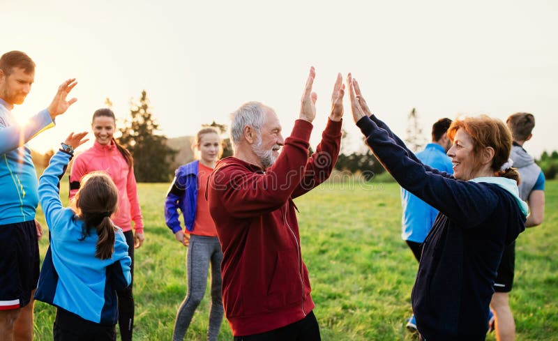 Large Group of Fit and Active People Resting after Doing Exercise in ...