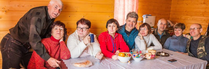 A Large Group of Old Friends are Sitting at the Table and Chatting ...