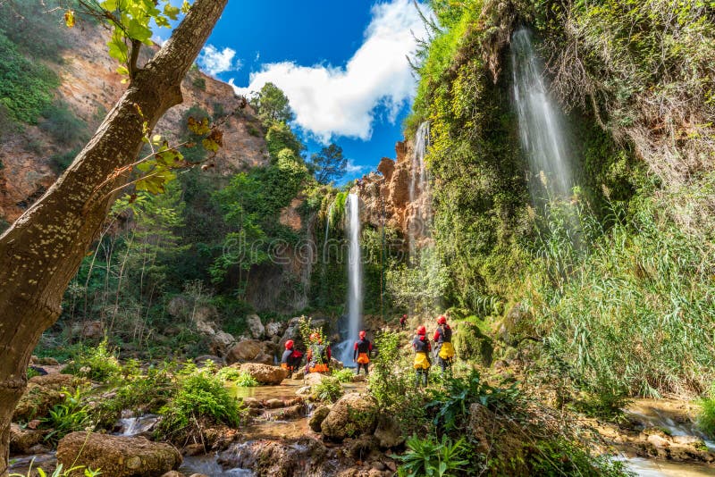 Large Group of People Enjoy Waterfall Descent Using Ropes Stock Photo ...
