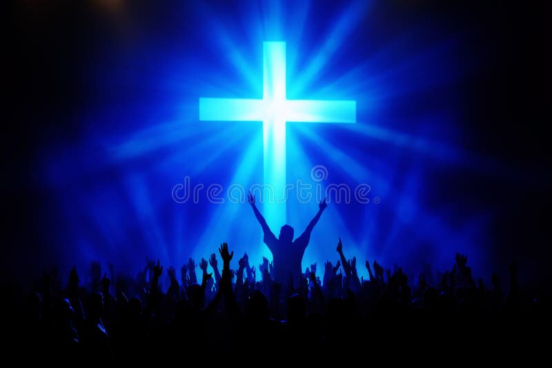 A Large Group of People Raising Hands in Praise with a Cross and ...