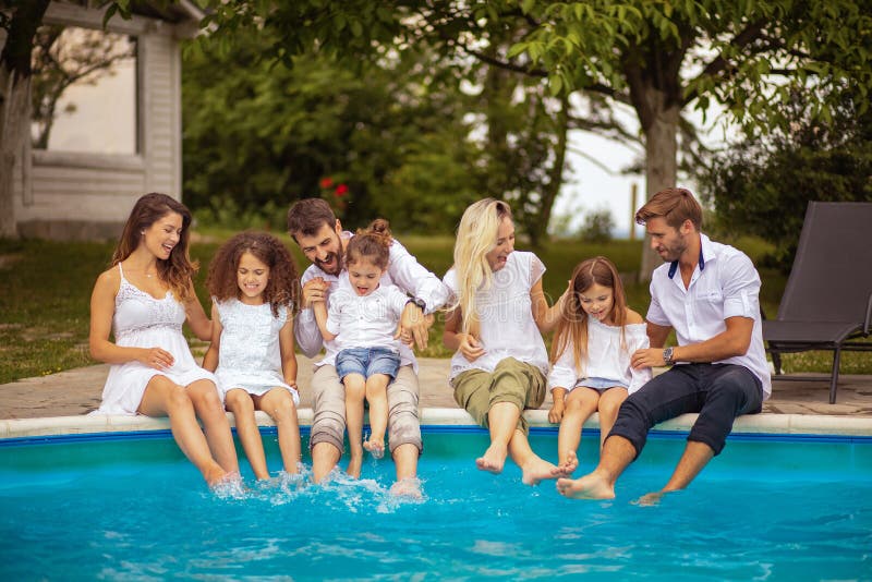 Group of People Sitting by the Swimming Pool Stock Image - Image of ...