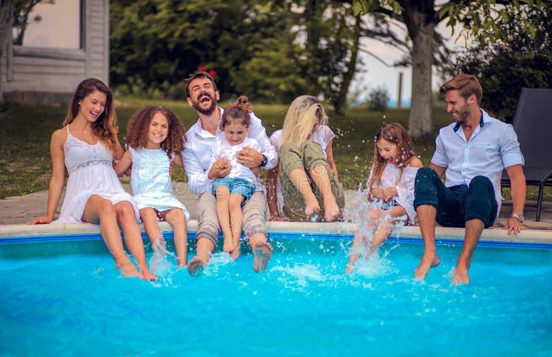 Group of People Sitting by the Swimming Pool Stock Photo - Image of ...