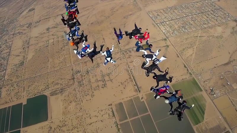 A Large Group of Skydivers Form Free-fall Formations. Difficult and ...