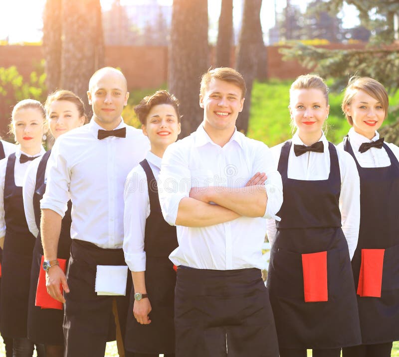A Large Group of Waiters and Waitresses in the Open Air Stand One after ...