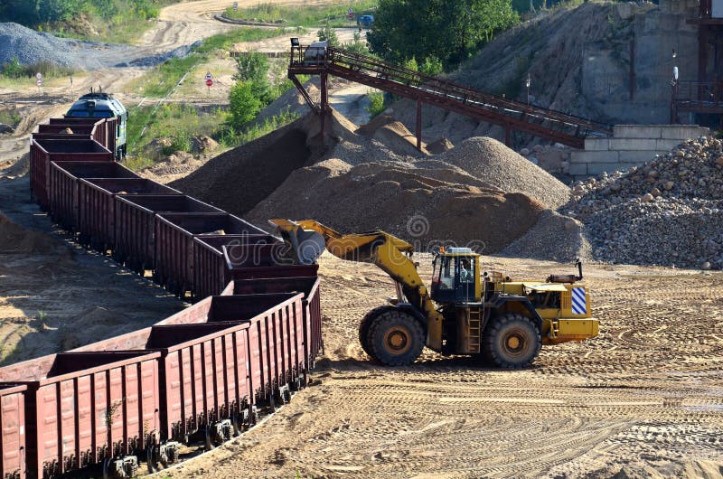 Large Heavy Front-end Loader Loading Sand it To the Freight Train ...