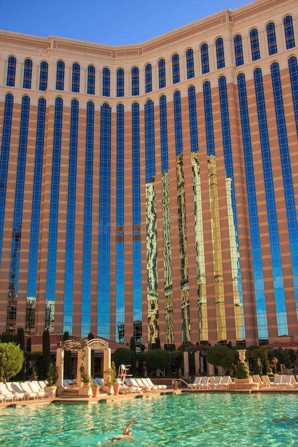 A Large Hotel with a Pool and a Man Swimming in it Editorial Stock ...