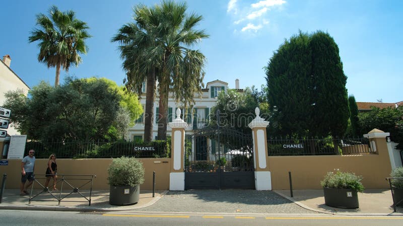 A Large Channel Boutique House with a White Gate and a Palm Tree in ...