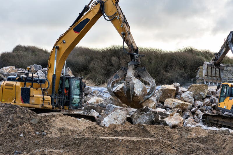 Large Hydraulic Excavators Working As a Team on a Construction Site ...