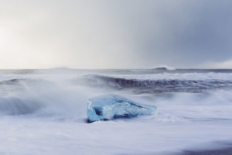 Large Iceberg Floating in the Ocean, with White Foam from the Waves ...
