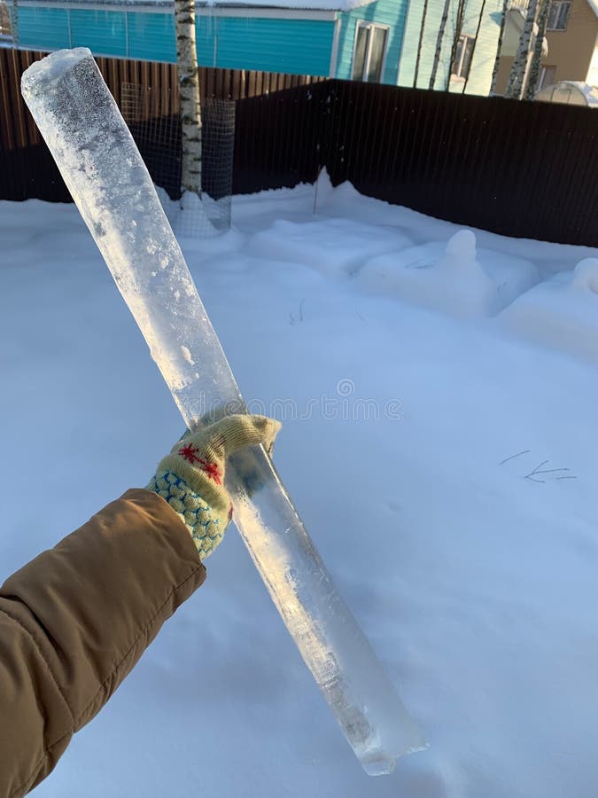 A Large Icicle Fell from the Roof. Danger of Falling Huge Icicles Stock ...