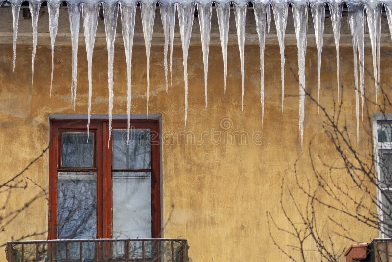 Large Icicles Hang from the Roof of an Old House. Danger of Icicles ...