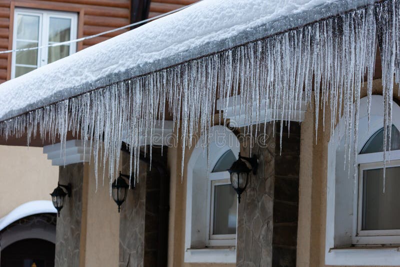 Large Icicles on the Roof of the House. Danger from Falling Icicles ...