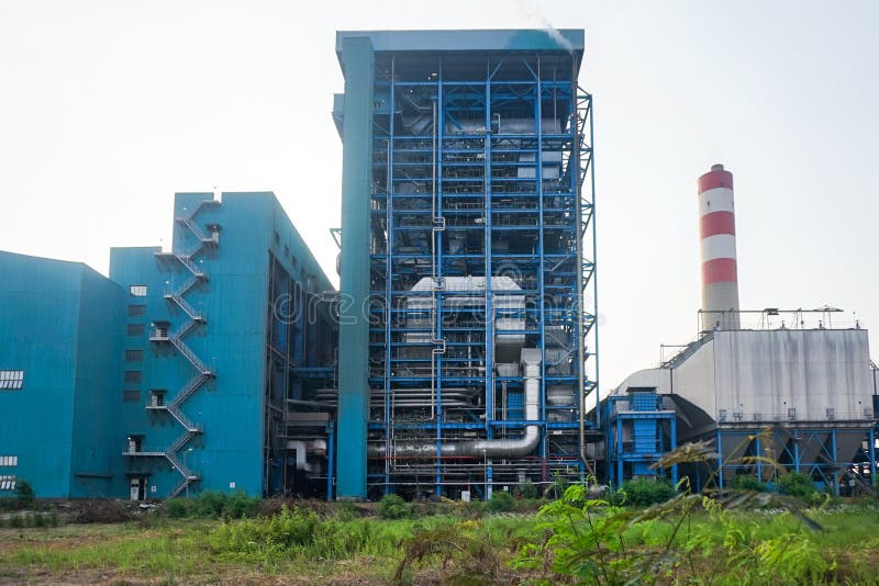 Large Industrial Complex Featuring a Tall Smokestack and Metal ...