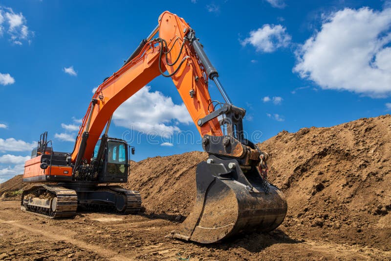 A Large Industrial Excavator Work on the Construction Site. Cloudy Sky ...