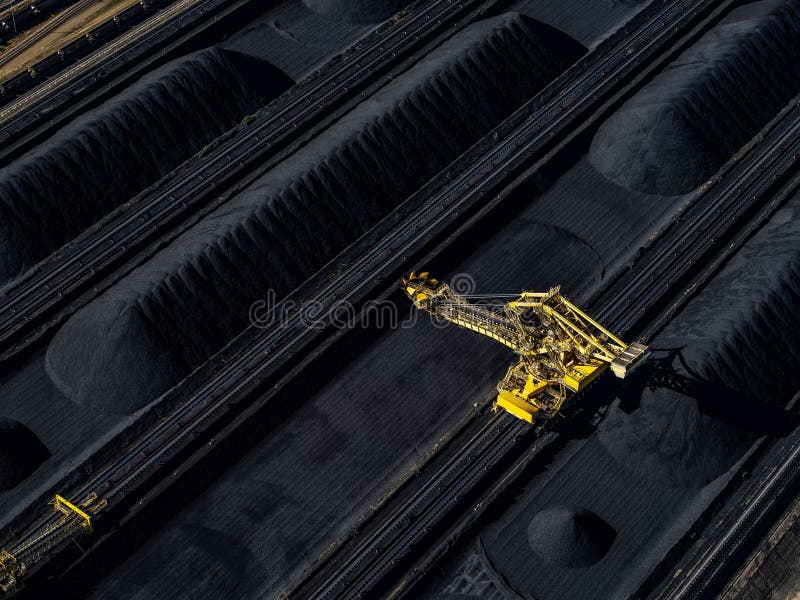 A Large Machine is on Top of Some Tracks with Coal Stock Photo - Image ...