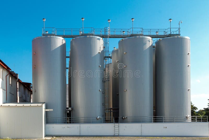 Large Industrial Tanks Against the Bright Blue Sky Stock Image - Image ...