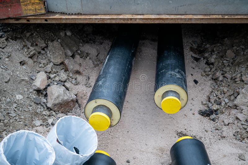 Large Insulated Underground Pipes with Yellow End Caps at a ...