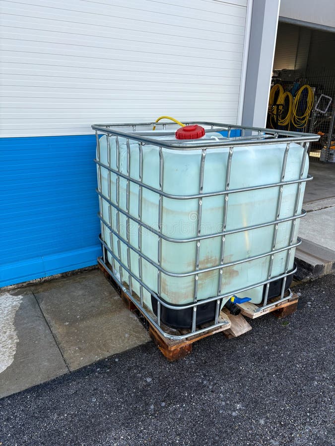 A Large Intermediate Bulk Container Filled with Liquid Sits Outside a ...