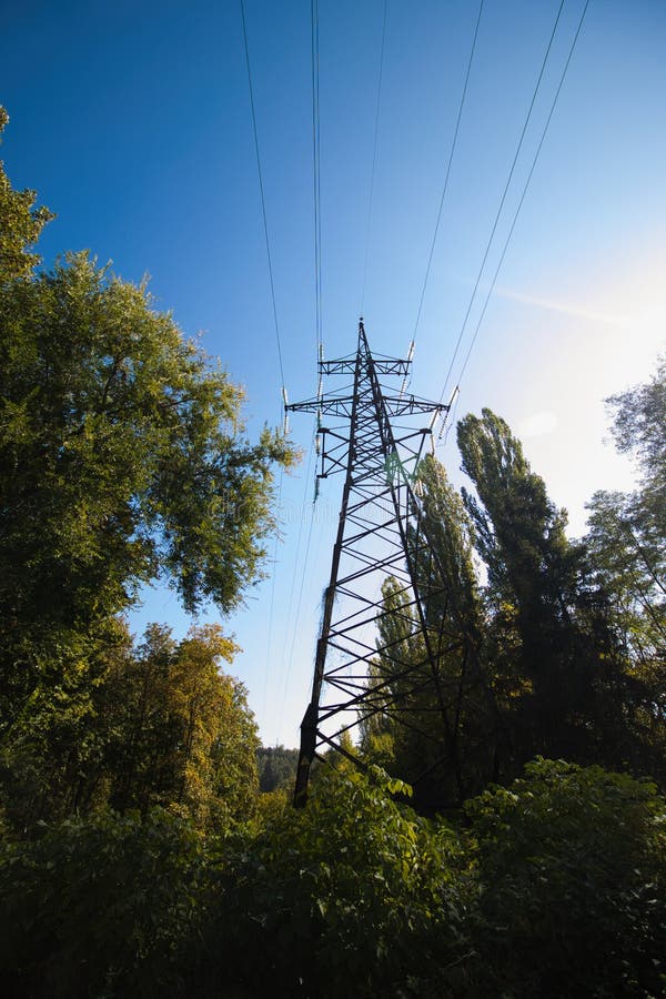 Large Iron Tower of Power Lines in Green Area Under Sky Stock Image ...