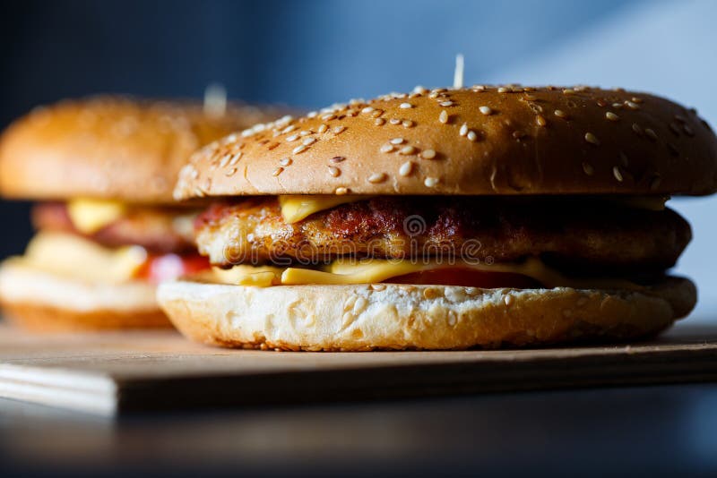 Large Juicy Burger with Cutlet Cheese and Tomatoes. Fast Food. Stock ...