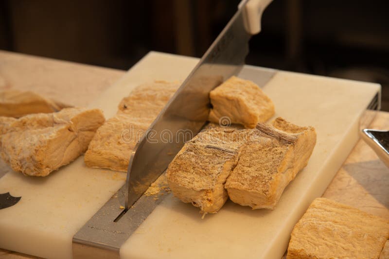 Knife Slicing Dry Fish on White Board with Focused Texture Stock Image ...