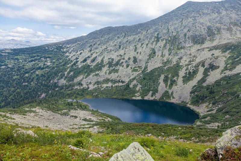 A Large Lake among Sheer Cliffs Stock Photo - Image of peaks, forest ...