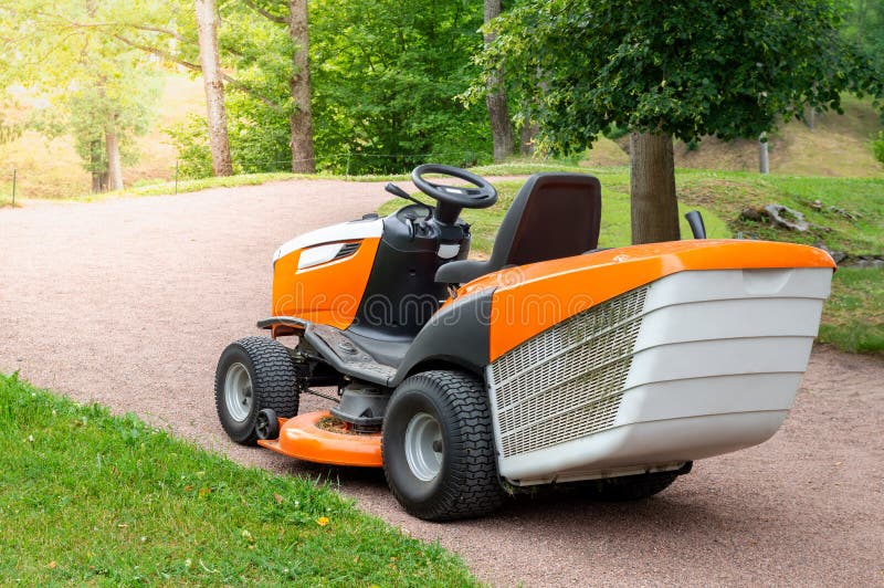 A Large Lawn Mower on the Path in the Park during Sunset Stock Image ...