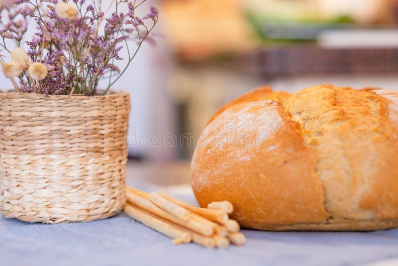 Large Loaf of Bread on the Home Table. Bread Sticks, Basket of Dried ...