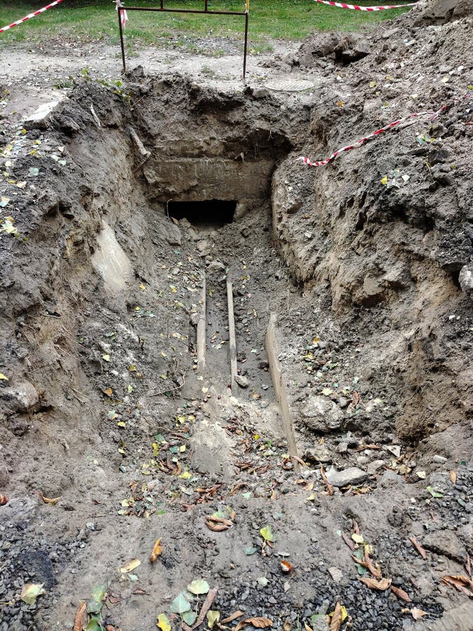 A Large Long Pit with Old Pipes at the Bottom during the Elimination of ...