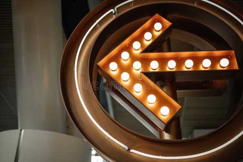 Large Luminous Arrow Decorated with Light Bulbs in the Background of ...