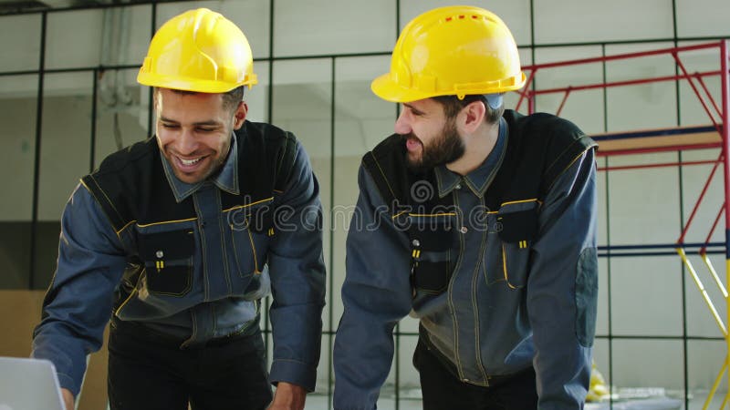 In a Large and Luminous Industrial Building Teo Constructor Men Have a ...