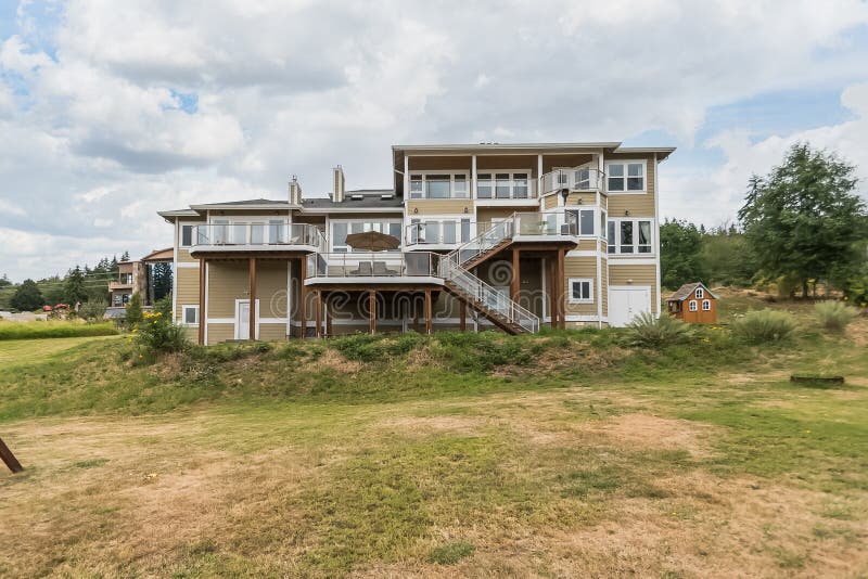 Large Luxury Home with Blue Sky and Green Grass Yard Multi-level ...