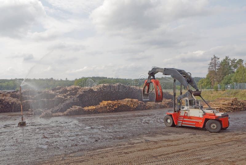 Large Machine Loading Timber at the Pulp and Paper Mill Stock Photo ...