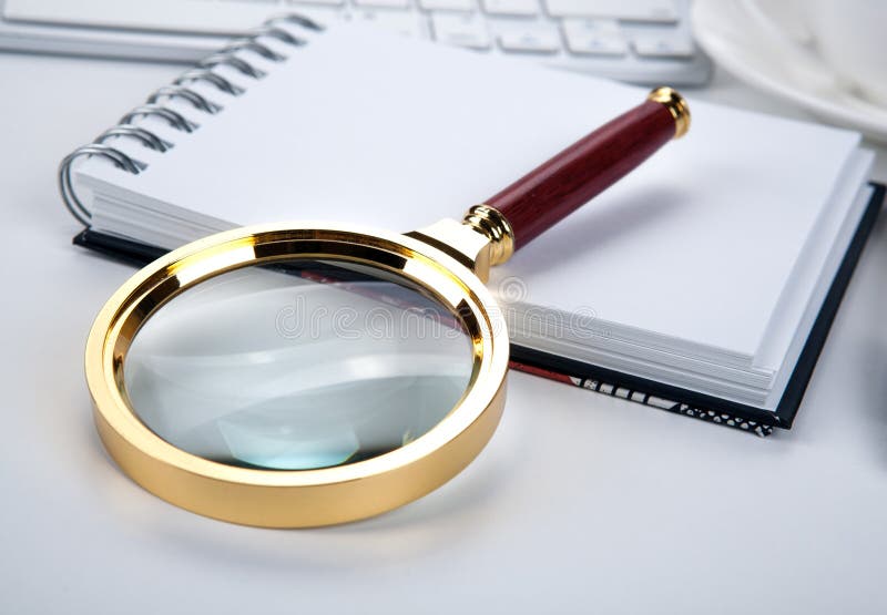 Large Magnifying Glass Lies on a Notebook on the Desktop Stock Photo ...