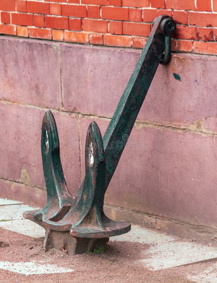 A Large Metal Anchor Against the Wall of a Brick House Stock Image ...