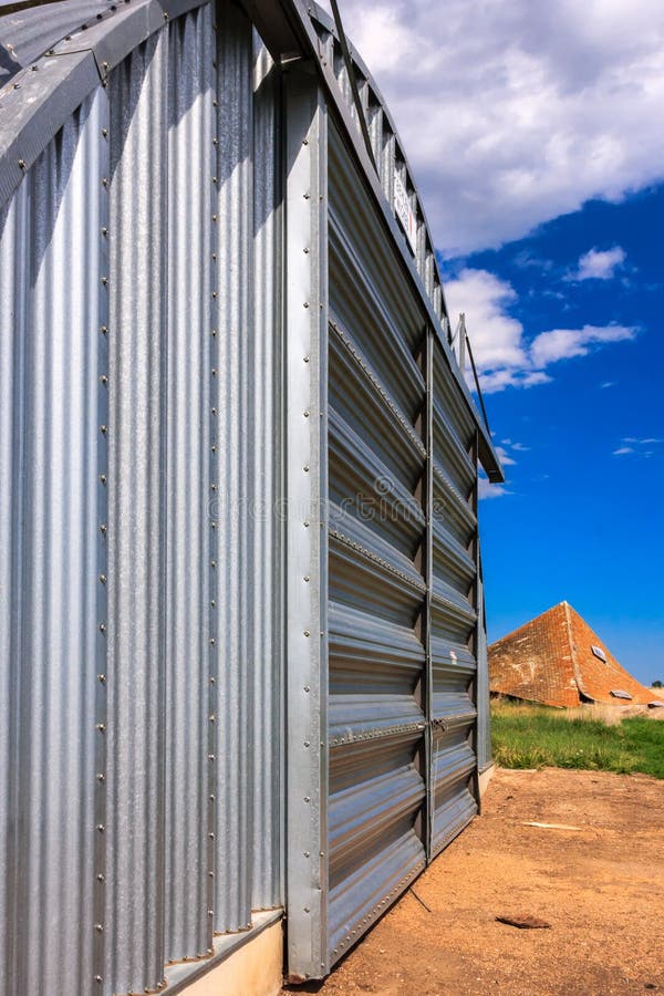 A Large Metal Building with a Pyramid in the Background Stock Image ...