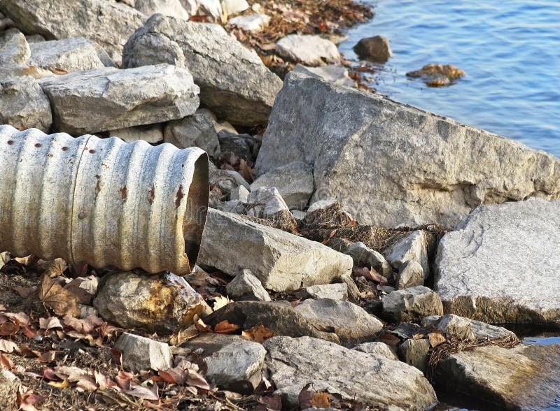 Large Metal Drain Pipe on Rocky Shore Line of Lake Stock Photo - Image ...