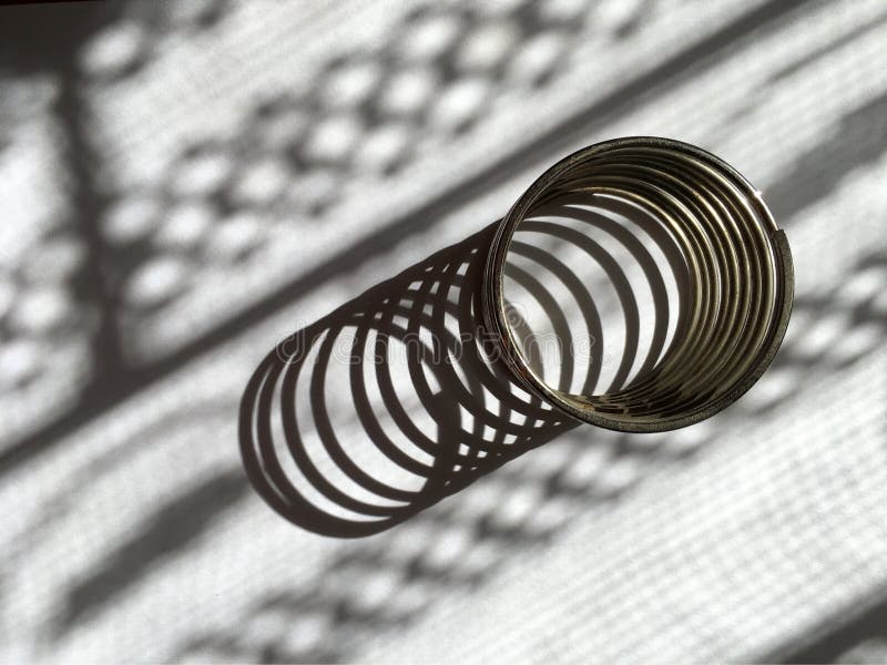Large Metal Spring Casts a Shadow Stock Image - Image of metallic ...