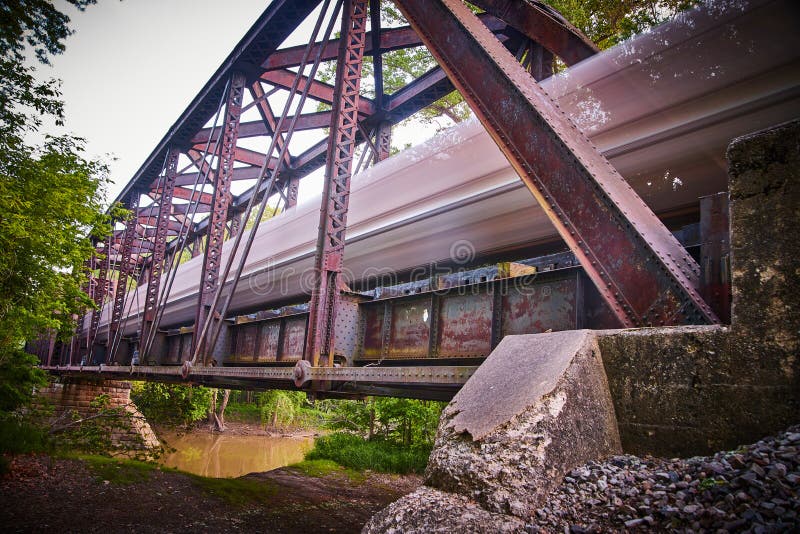 Large Metal Train Track from Below with Blur of Train Stock Photo ...