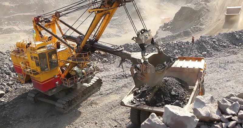 Loading Iron Ore into Mining Excavator. a Large Mining Excavator is ...
