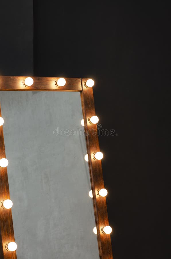 A Large Mirror with Backlight Against a Black Wall Stock Photo - Image ...